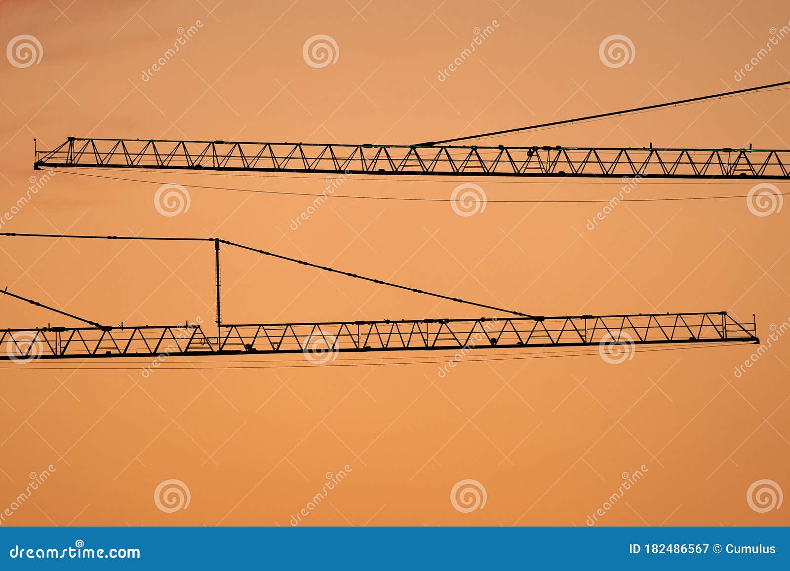 Two Construction Crane Arms in the Sky at Sunset. Stock Image - Image ...