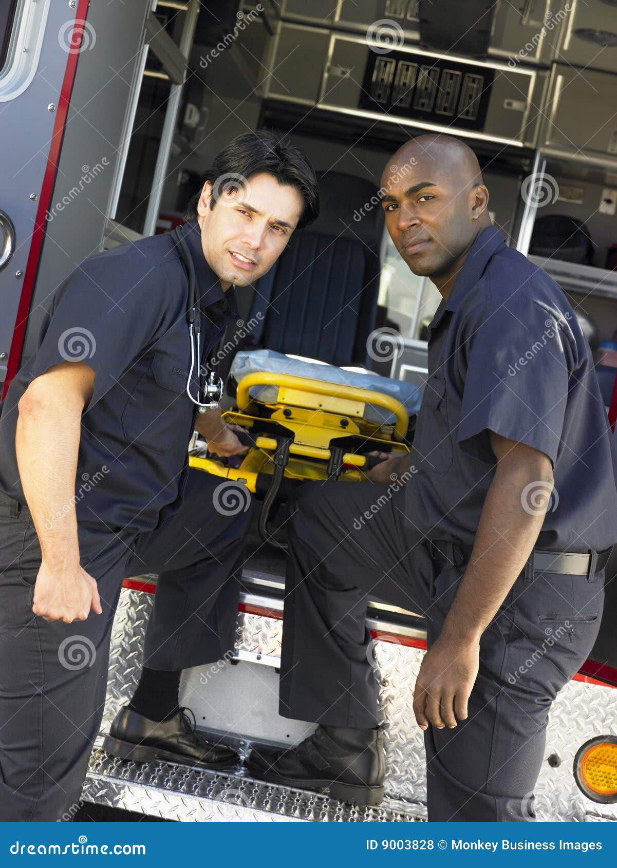 Two Paramedics Removing Gurney from Ambulance Stock Photo - Image of ...