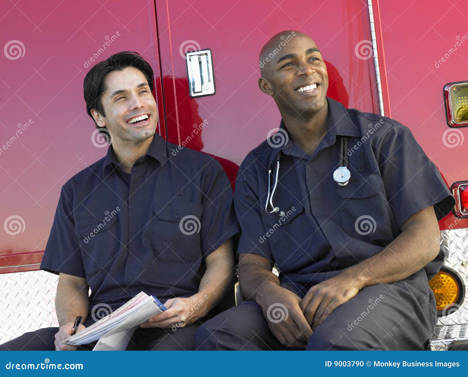 Two Paramedics Sitting by Their Ambulance Stock Photo - Image of ...