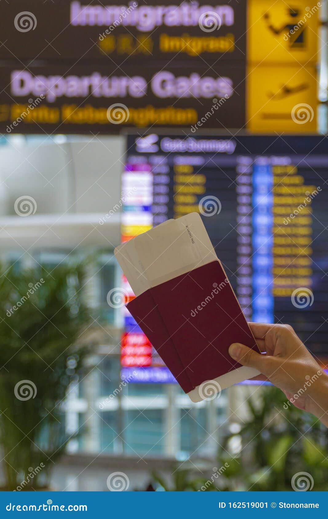 Two Passports And Boarding Passes In A Woman Hand Opposite The