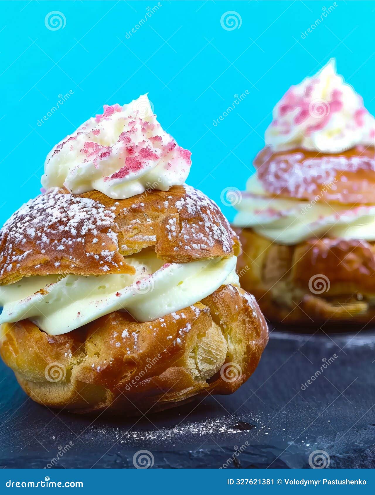 Two Pastries with Cream and Sprinkles on Top Stock Image - Image of ...