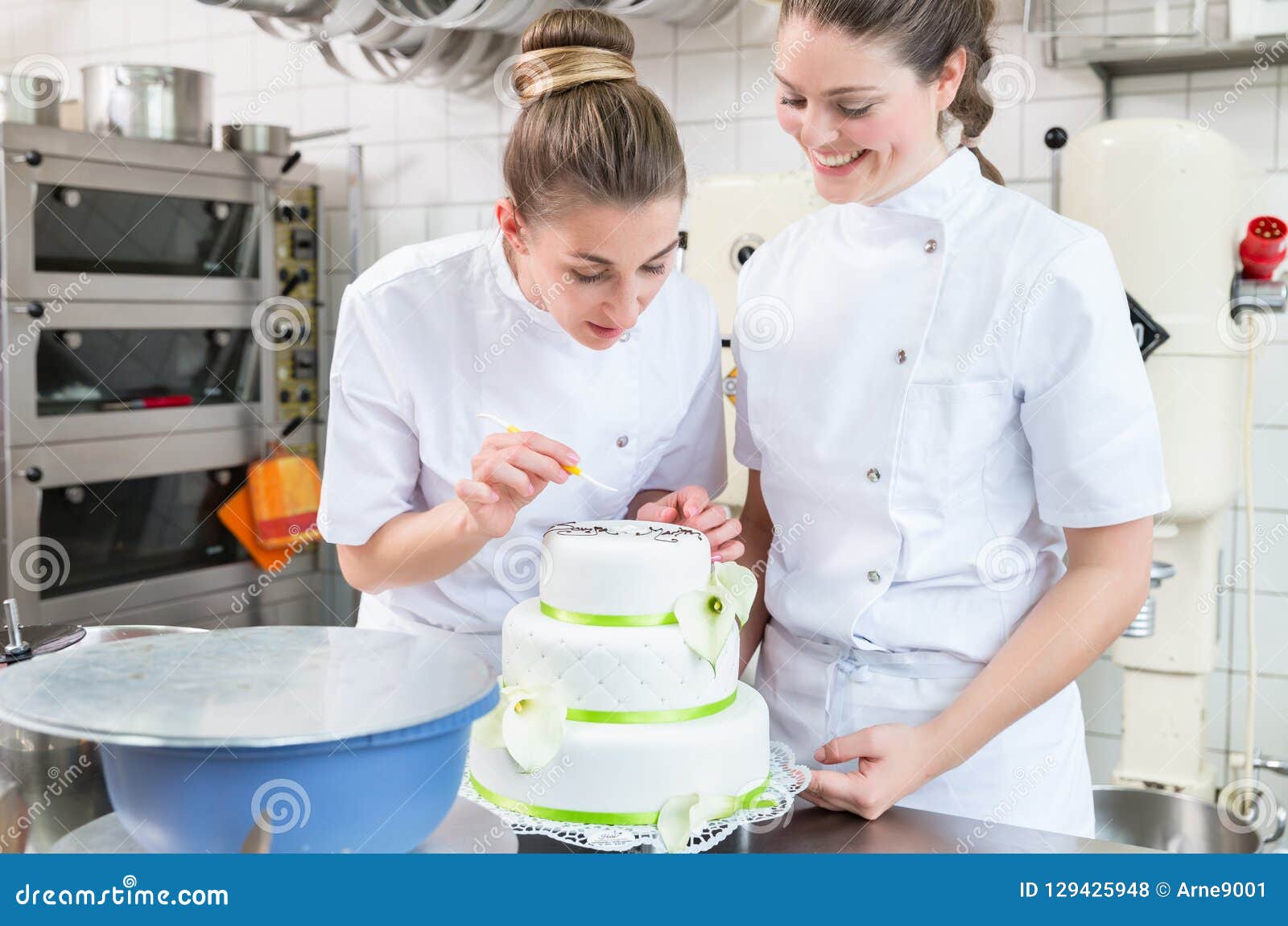 Two Pastry Bakers Decorating Large Cake Stock Photo - Image of pastry ...