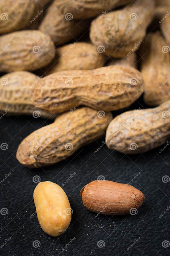 Two Peanuts without Shells Infront of a Pile of Peanuts Close Up Stock ...