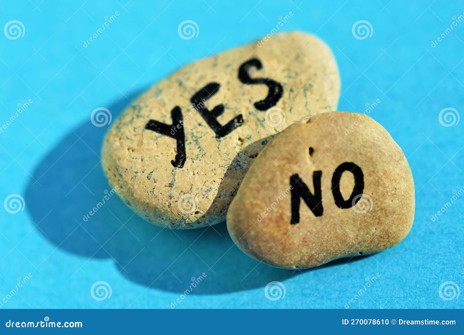 Two Pebble Stones with the Text Yes and No on a Sunny Blue Table Stock ...