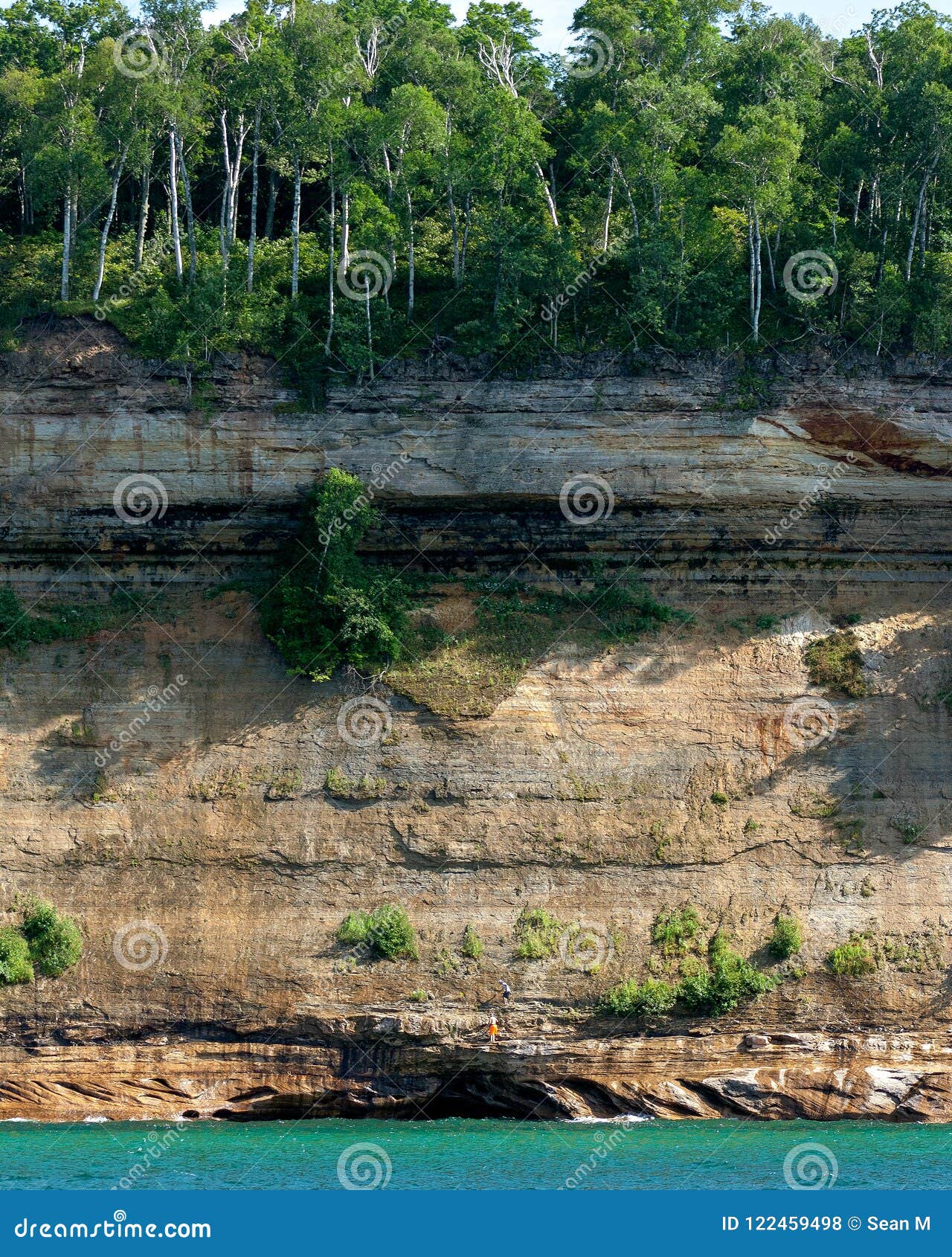 Tall Cliffs with Tiny Exlplorers Stock Photo - Image of cliff, face ...