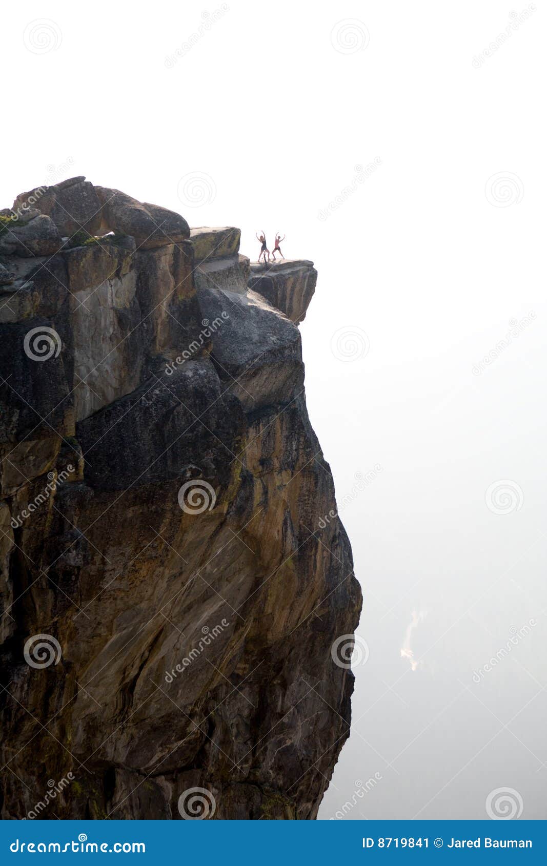Two people on cliff side stock image. Image of freedom - 8719841