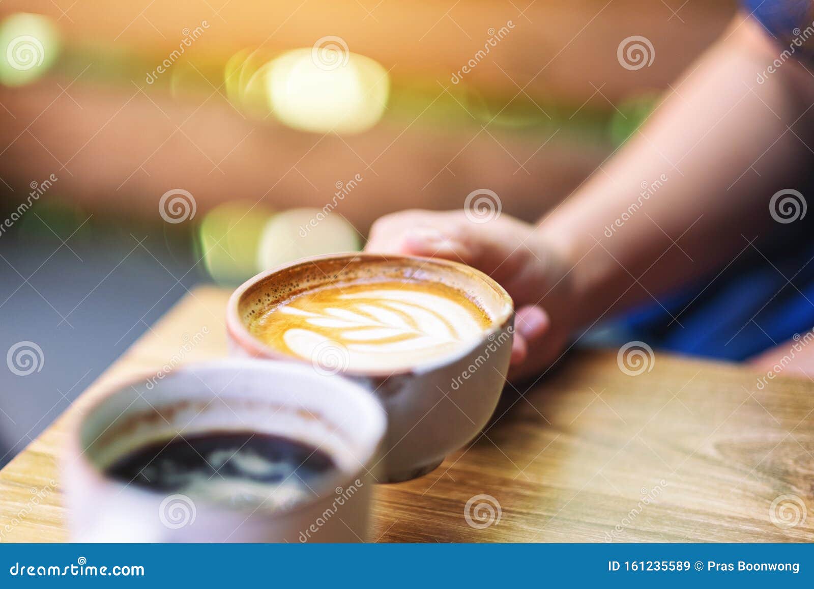 Two People Clinking Coffee Mugs on Wooden Table Stock Image - Image of ...