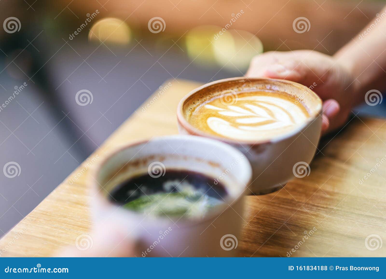 Two People Clinking Coffee Mugs on Wooden Table Stock Photo - Image of ...