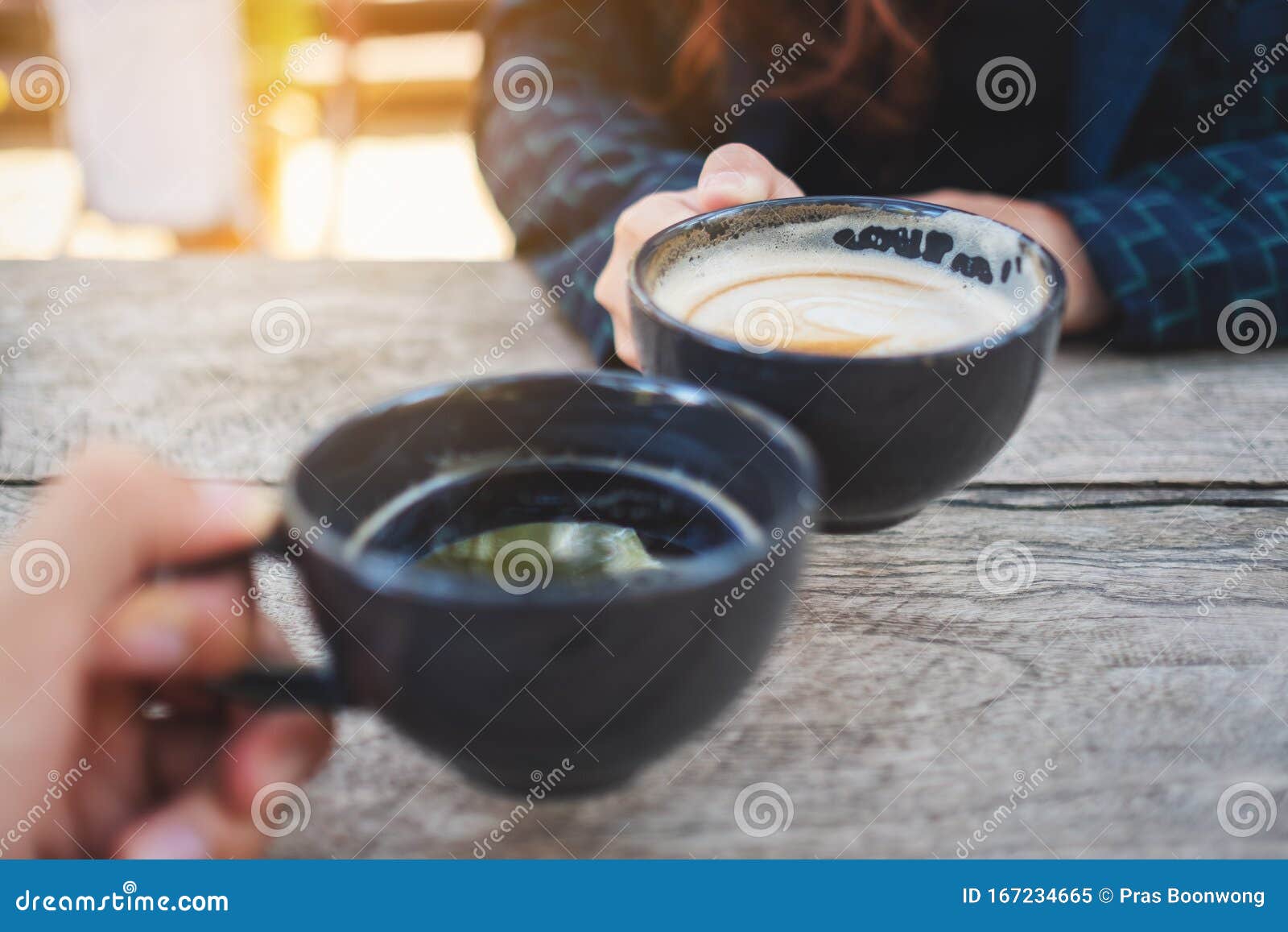Two People Clinking Coffee Mugs on Wooden Table Stock Image - Image of ...