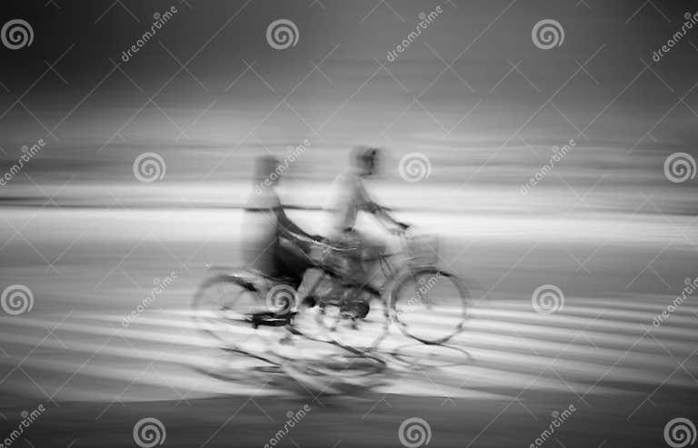 Two people cycling stock image. Image of street, stripe - 15120073