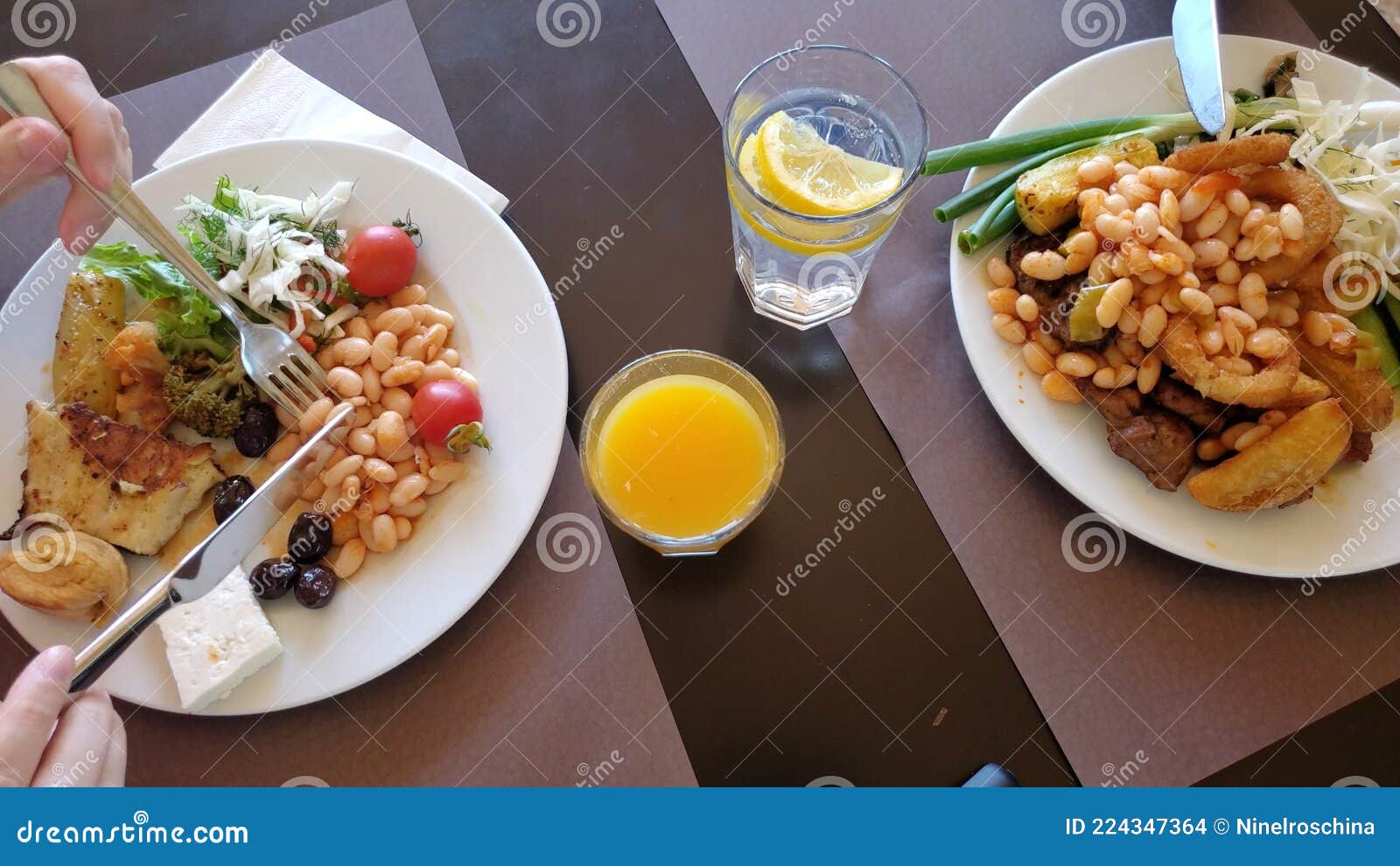 People Eating with Knives and Forks from Full Plates and Drinking ...