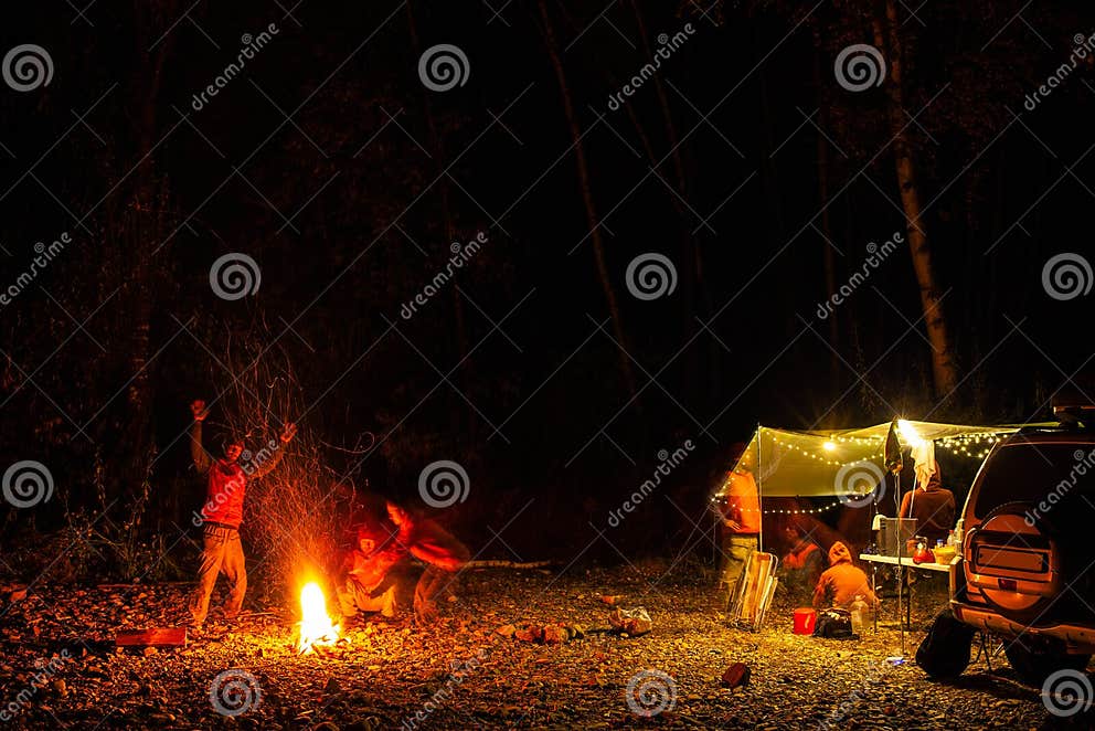 Two People are Having Fun Playing Ghosts at Their Forest Camping in the ...