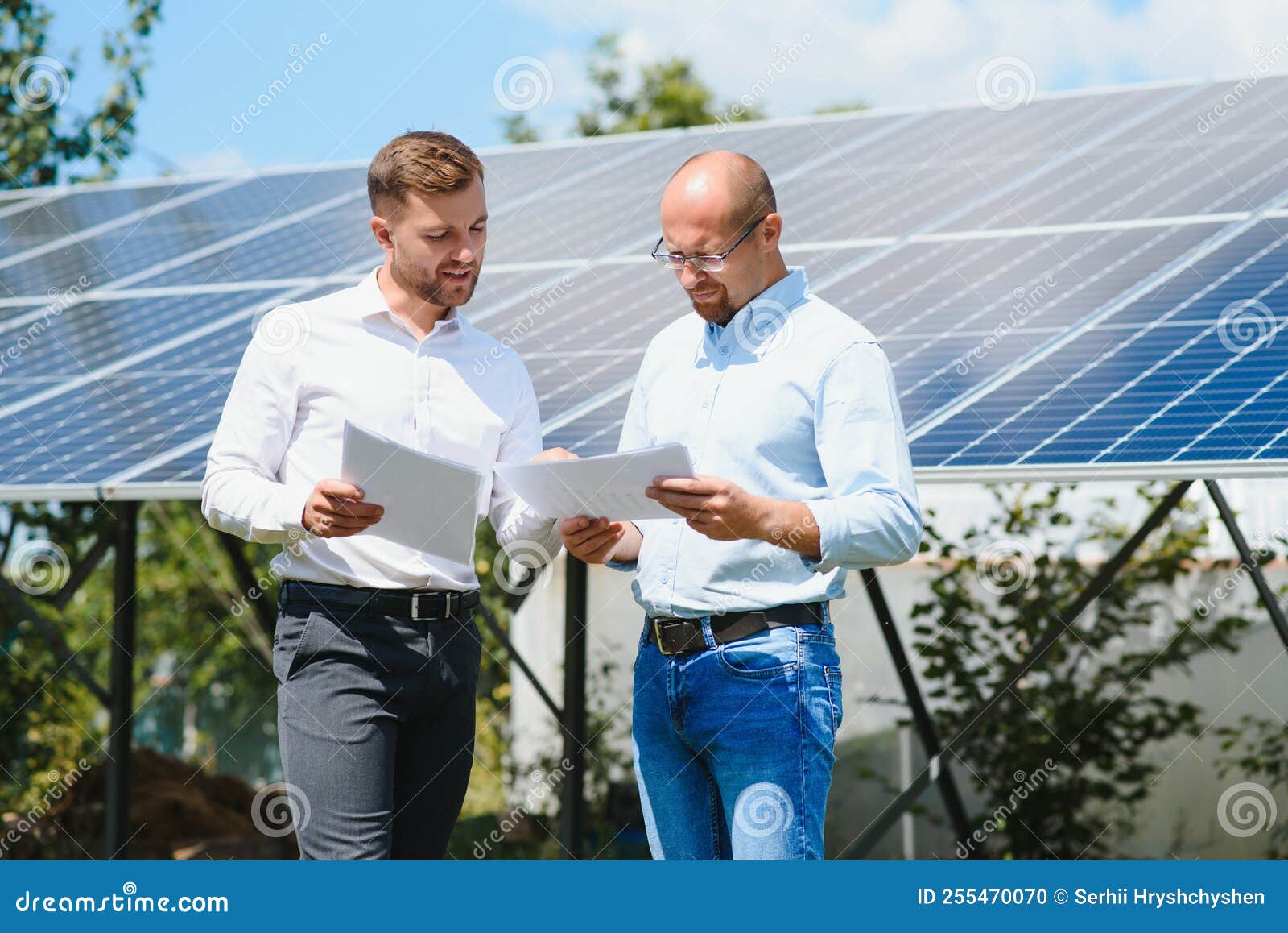 Two People Having a Shaking Hands Against Solar Panel after the ...
