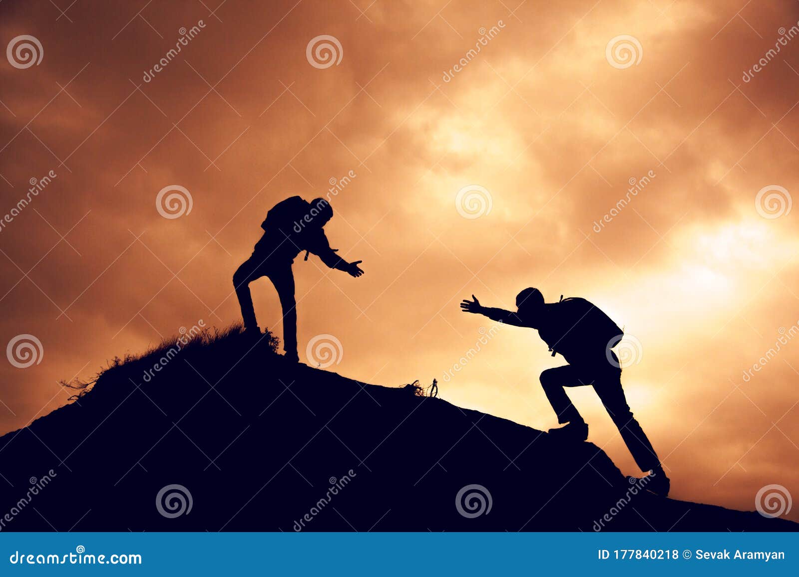 Two People Help Each Other on Top of a Mountain Climbing Team Stock ...