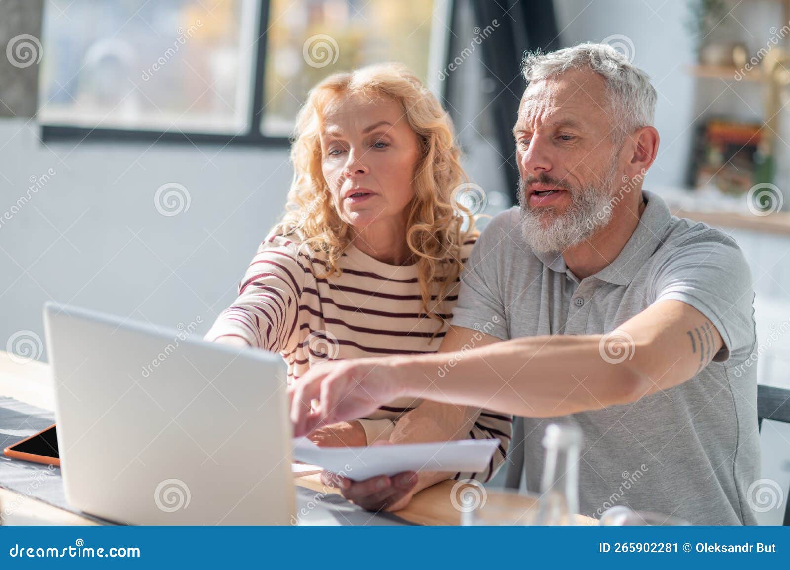 Two People at the Laptop Looking Involved and Discussing Something ...