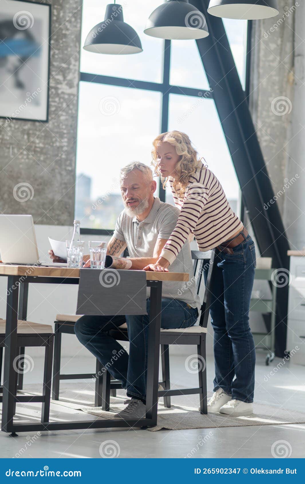 Two People at the Laptop Looking Involved and Discussing Something ...