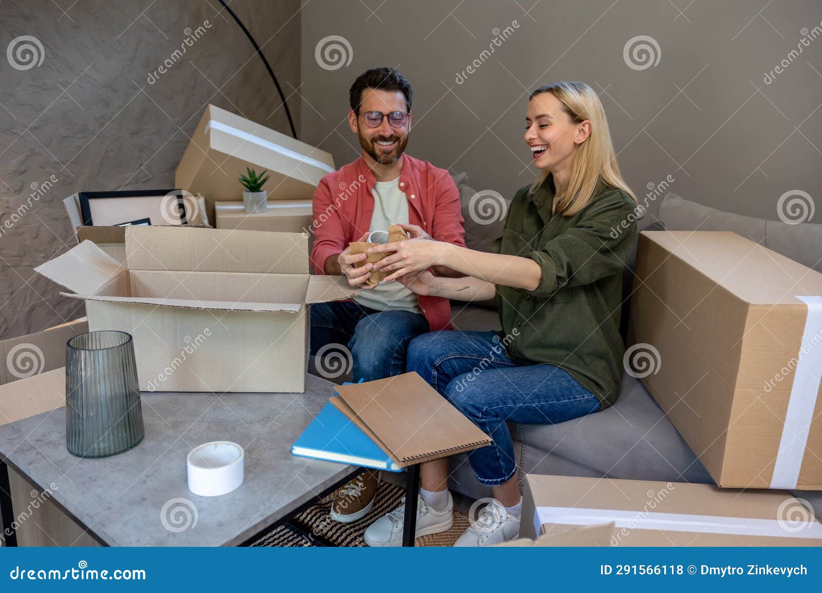 Two People Looking Busy while Packing the Boxes for Relocation Stock ...