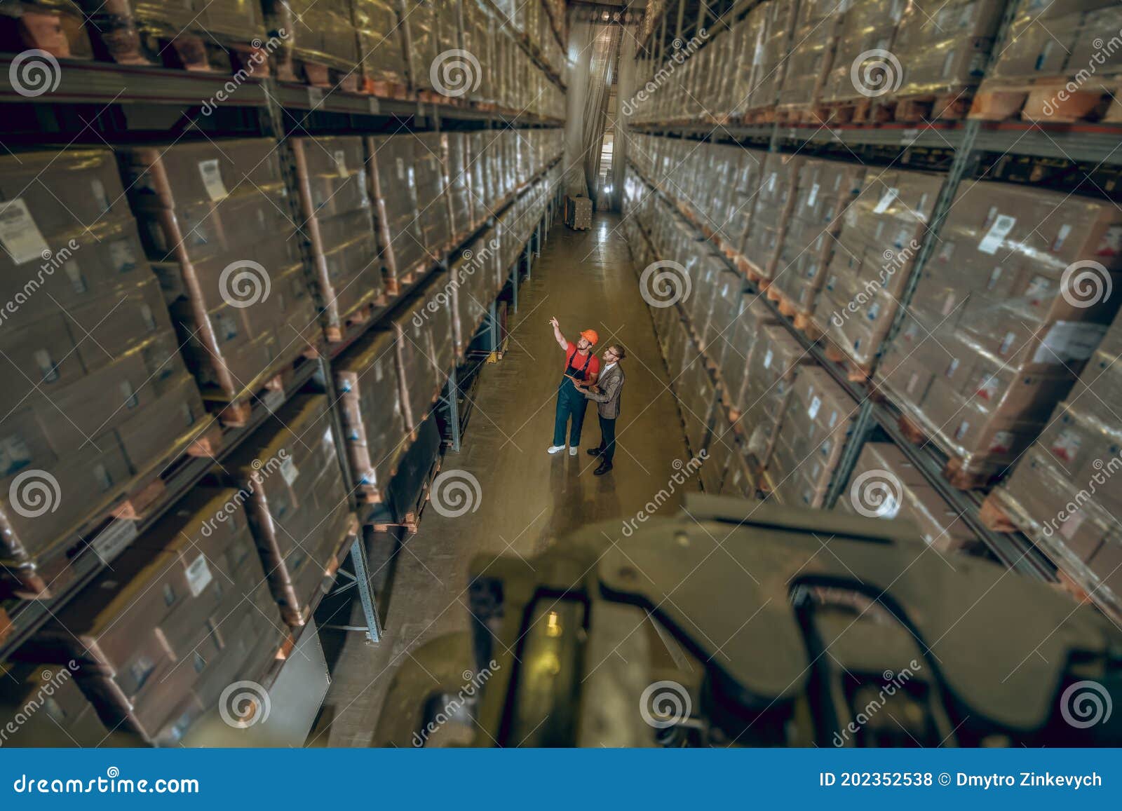 Two People in Megastore with Lots of Containers on the Shelves Stock ...