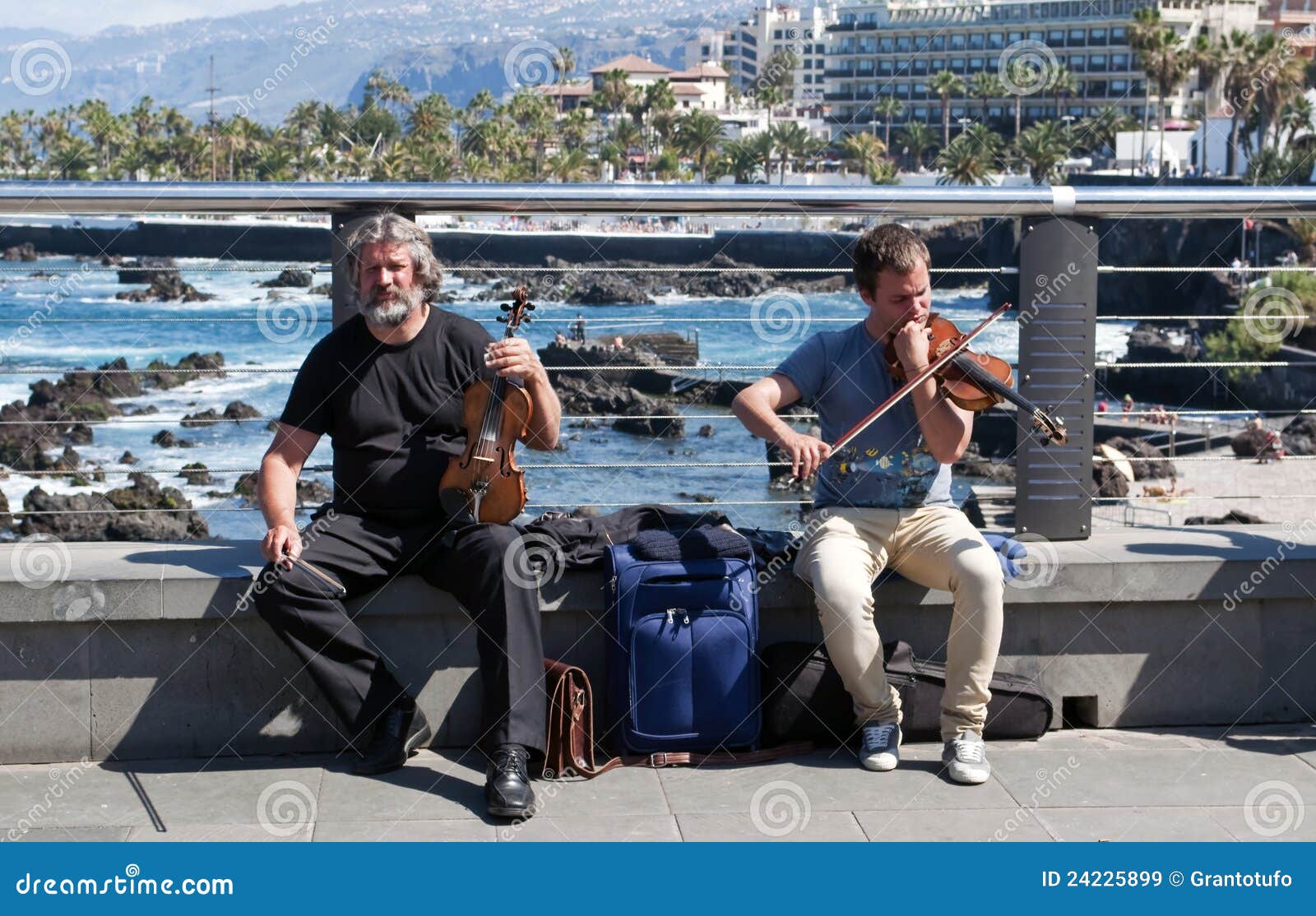 Two People Playing the Violin Editorial Stock Image - Image of rocks ...