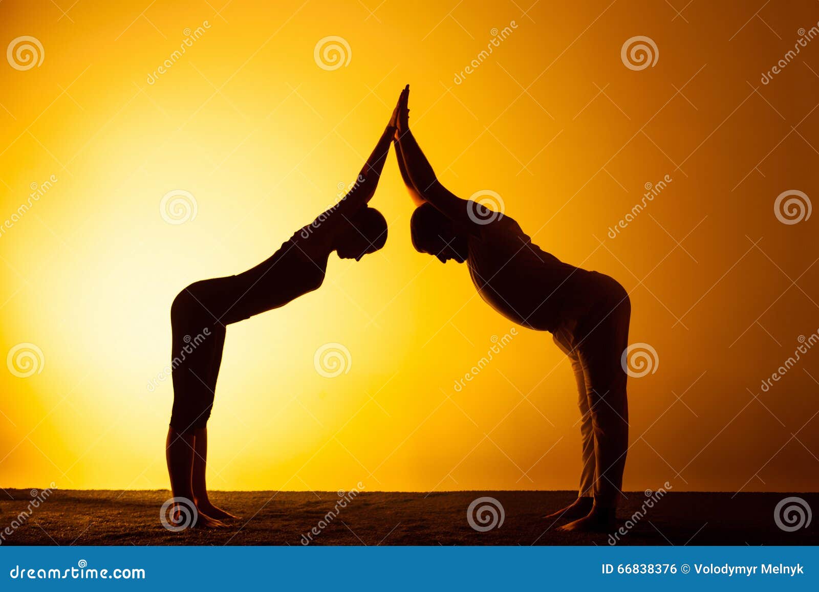 Two People Practicing Yoga in the Sunset Light Stock Photo - Image of ...