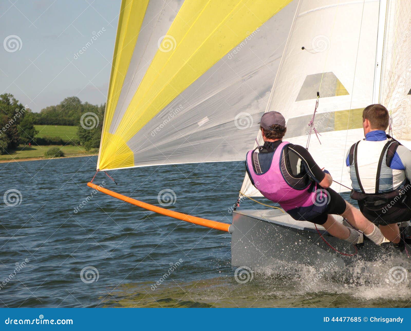 Two People Sailing A Small Grey Dinghy On A Lake Stock Image - Image of ...