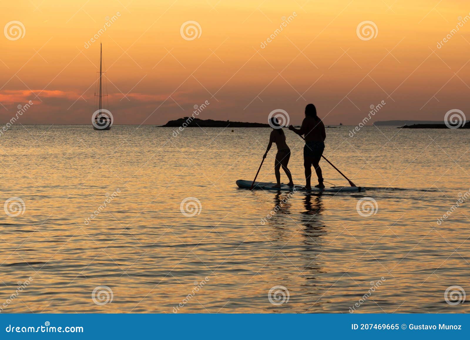 Two People on the Same Board of Paddle Surf at Sunset Stock Image ...