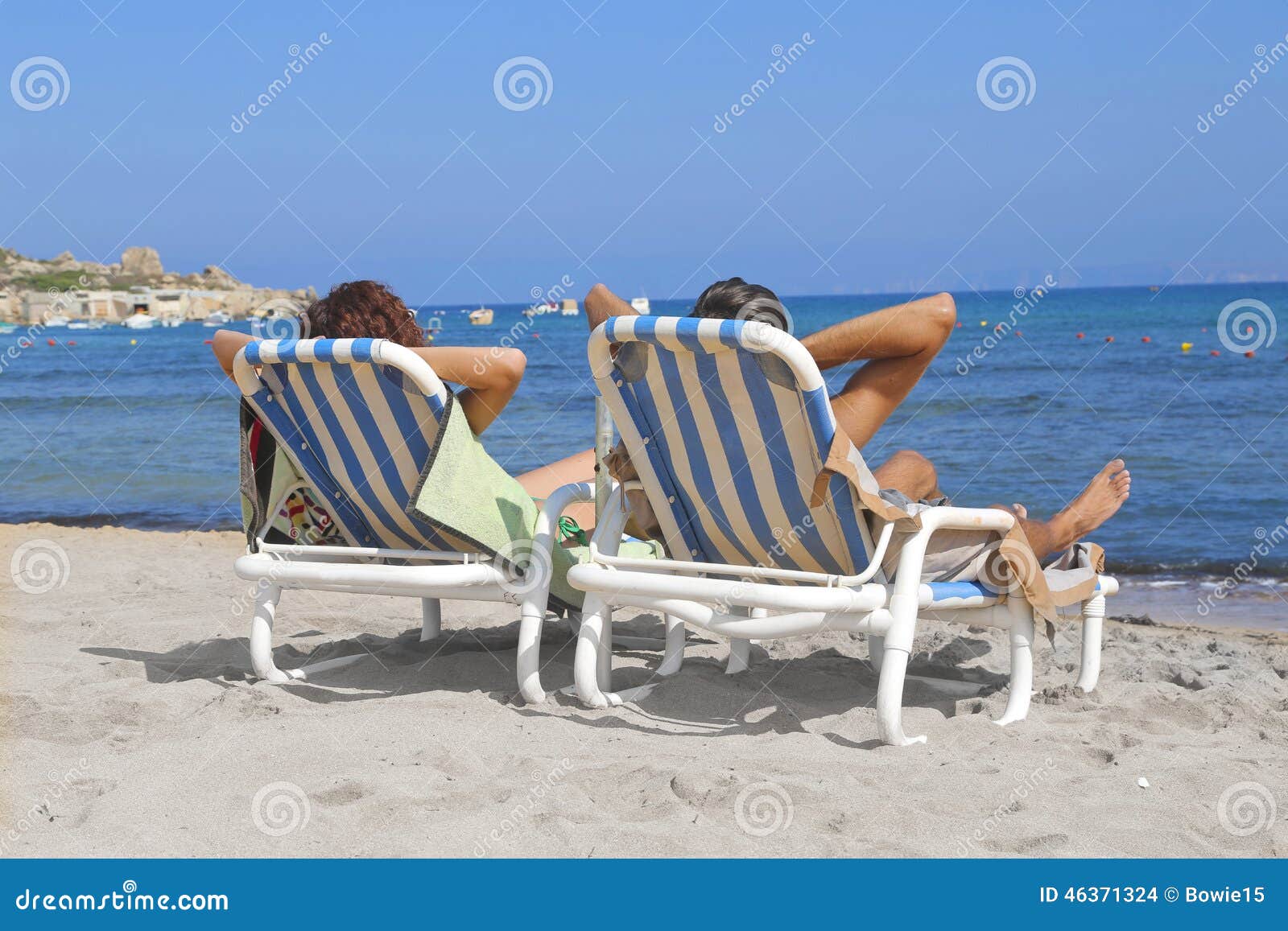 Two people at the seaside stock photo. Image of lying - 46371324