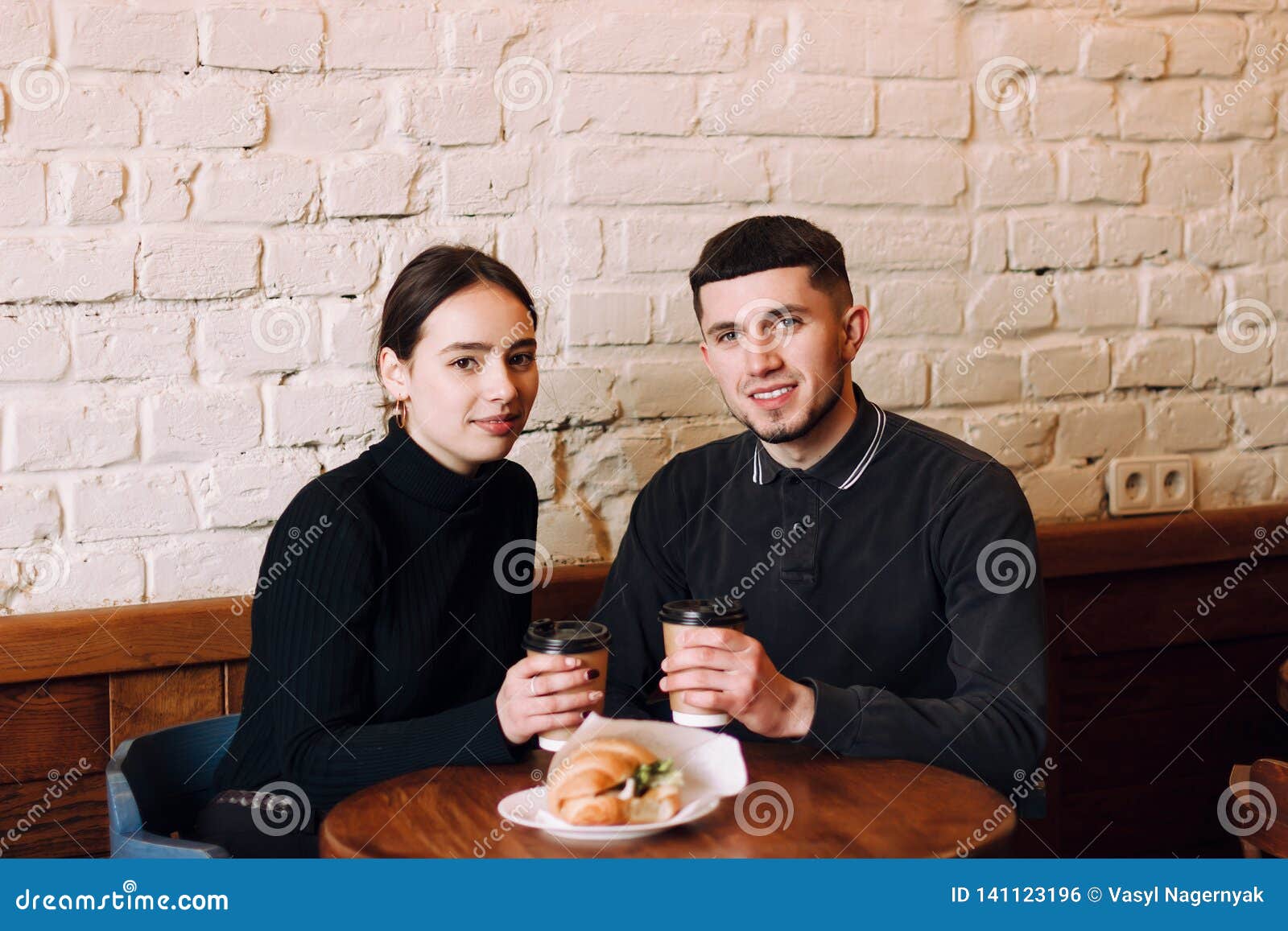 Two People Sitting in a Cafe, Having Breakfast, Drinking Coffe Stock ...