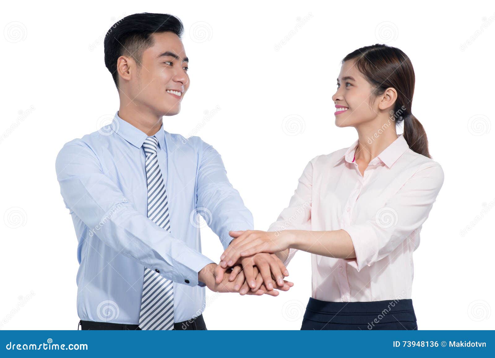 Two People Standing with Their Hands on Top Each Other and Smiling ...