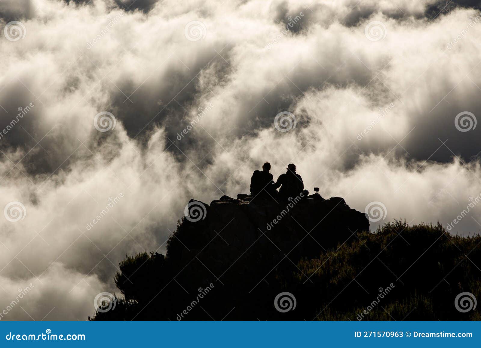 Two People on Top of a Mountain Above the Clouds Stock Image - Image of ...