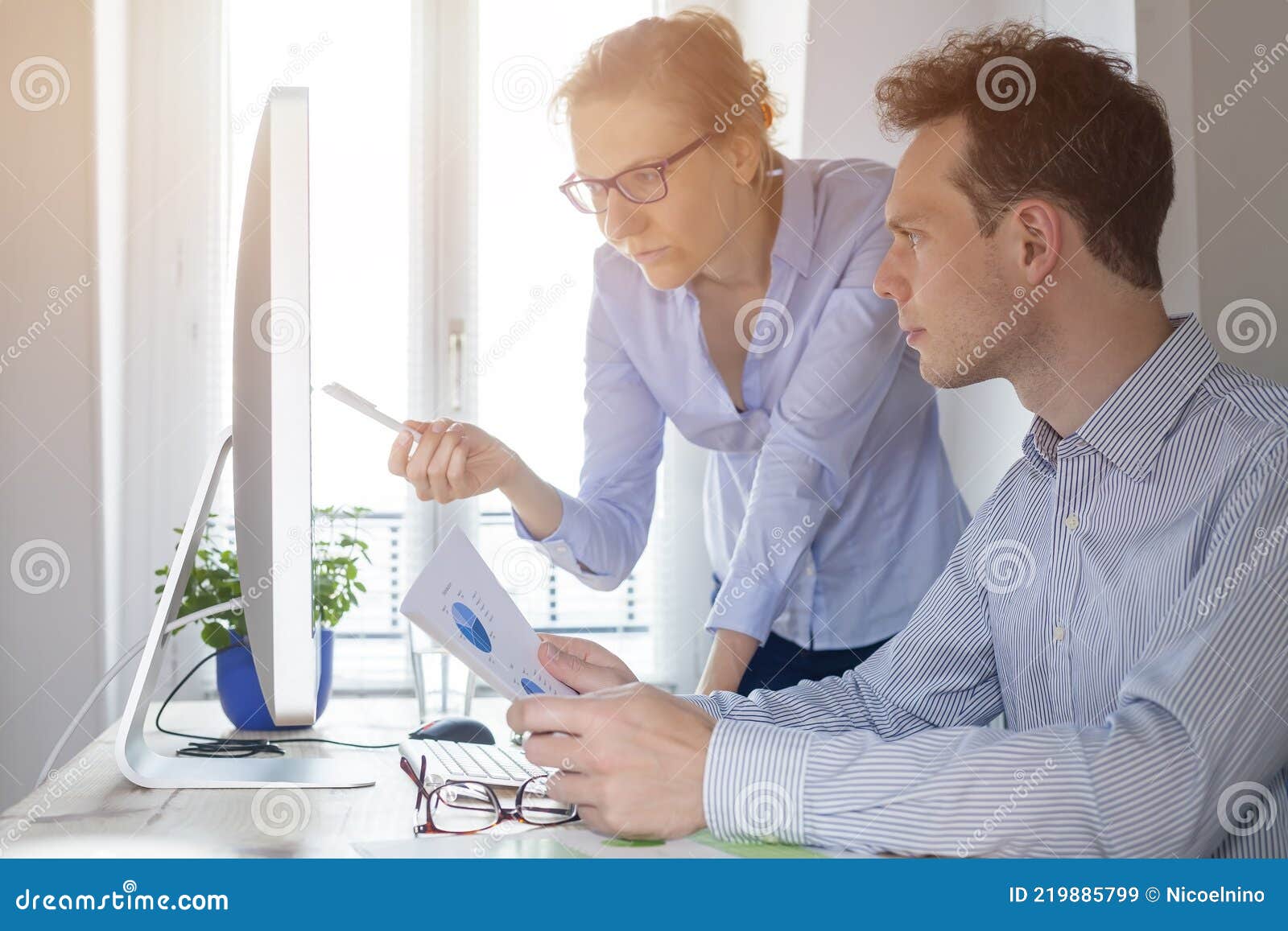 Two People Using Computer in Modern Office with Sunset Light Stock ...