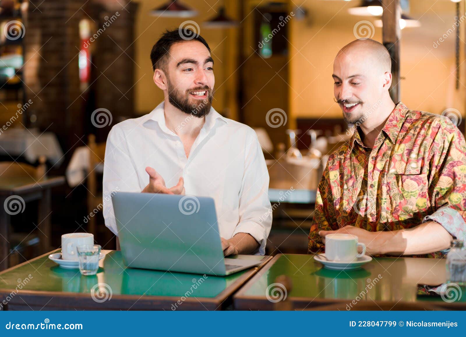 Two People Using a Laptop on a Meeting at a Coffee Shop. Stock Image ...