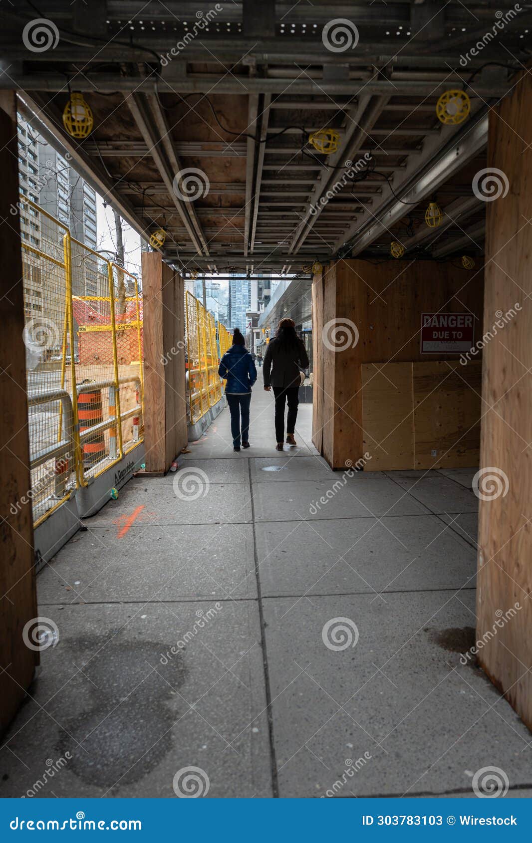 Two People Walk Under a Construction Structure in Downtown Toronto ...