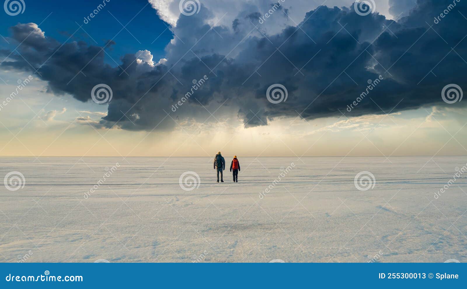 The Two People Walking through the Endless Snow Field. Stock Image ...