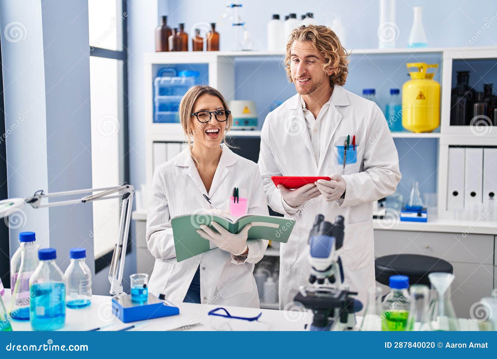 Two People Working at Scientist Laboratory Winking Looking at the ...