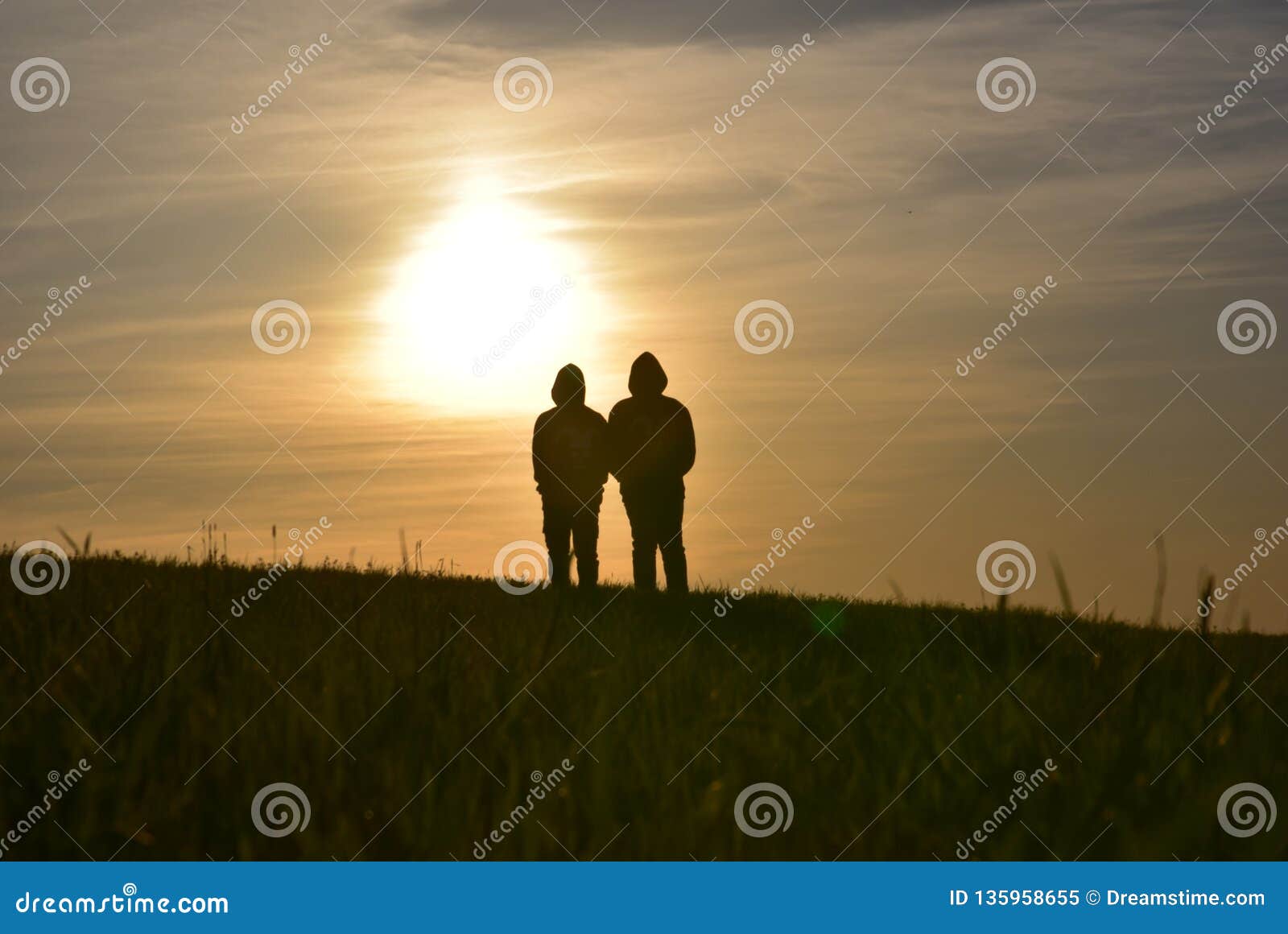 Two Person in Front of the Sunset Stock Image - Image of grass, person ...