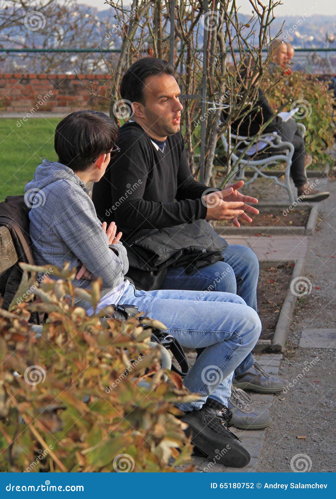 Two Persons are Talking at the Bench in Park of Editorial Photography ...