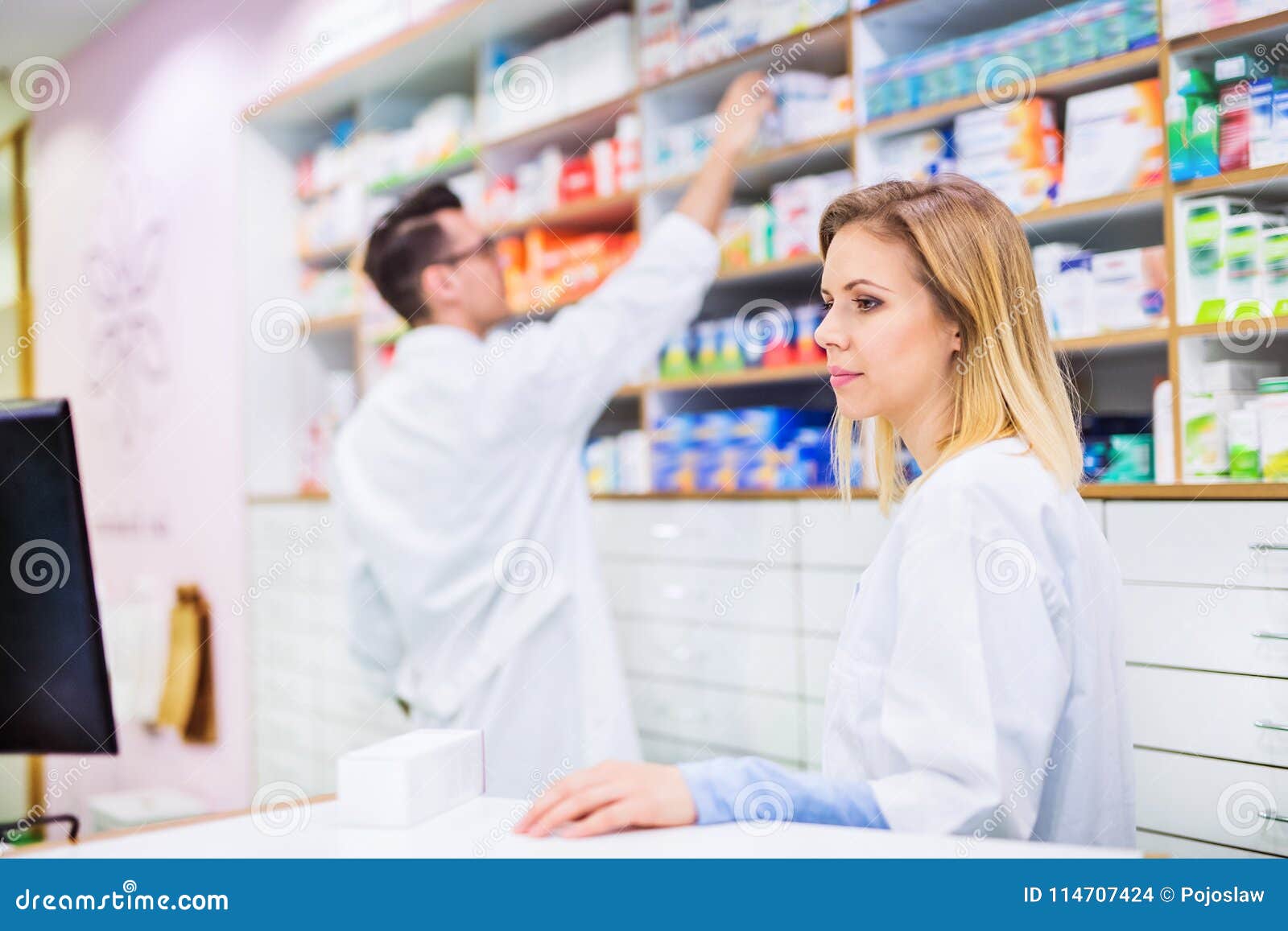 Two Pharmacists Working in a Drugstore. Stock Photo - Image of interior ...