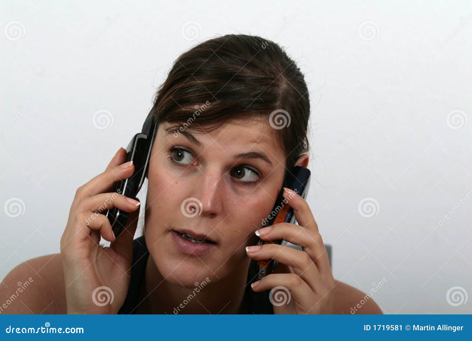 On Two Phones stock image. Image of beautiful, eyes, look - 1719581