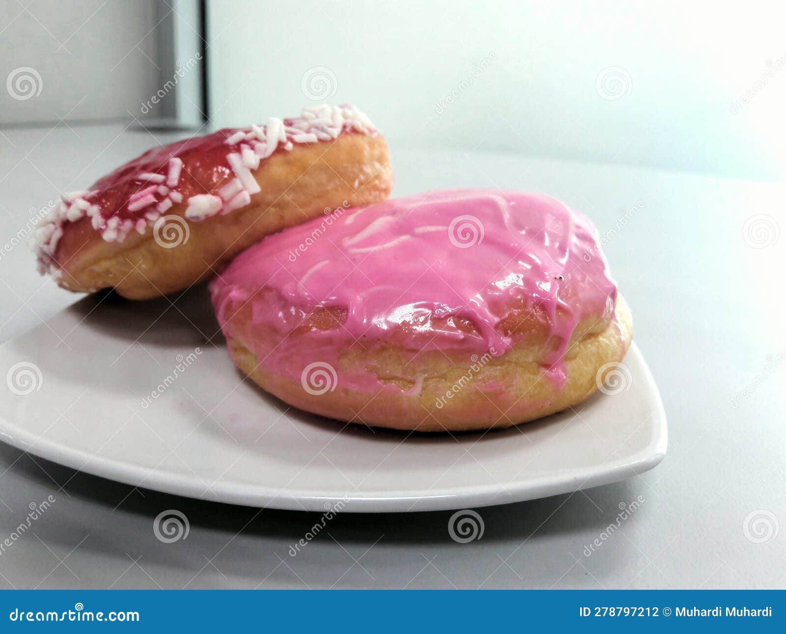 Two Pieces of Donut Served on a White Plate on the Table Stock Photo ...