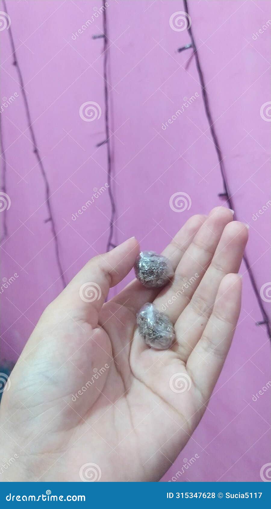 Two Pieces of Tamarind Candy in Hand Stock Photo - Image of asam ...