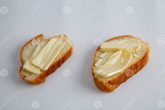 Two Pieces of White Bread with Butter on White Background Stock Image ...