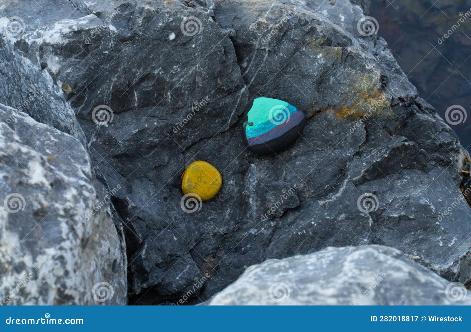 Two Pieces of Yellow and Blue Rock Sit among the Rocks Stock Image ...