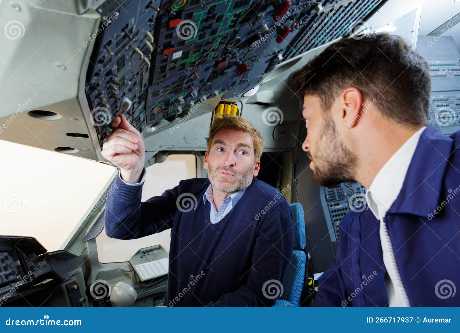 Two Pilots Communicating and Discussing in Cockpit Stock Image - Image ...