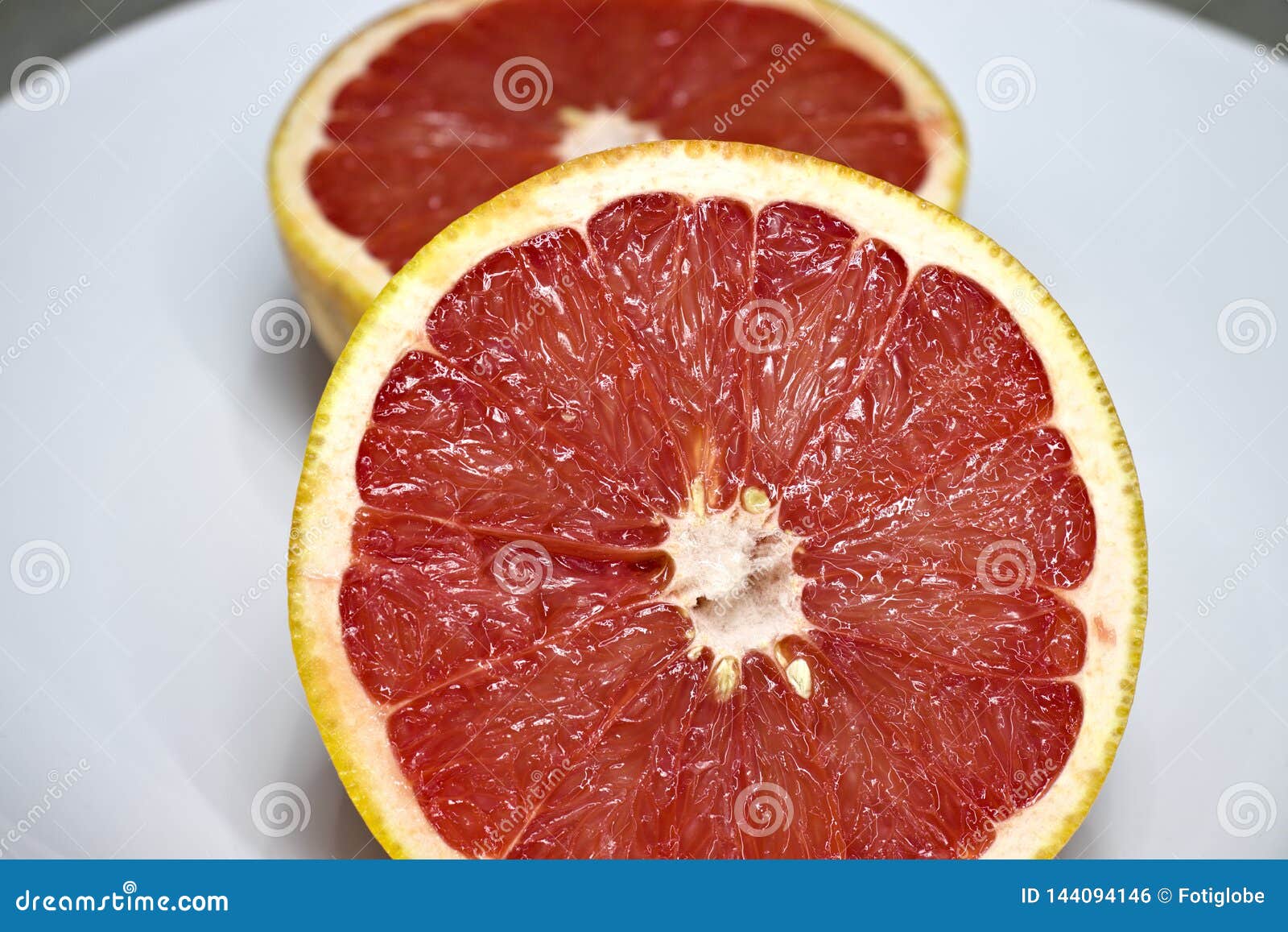 Two pink grapefruit halves stock photo. Image of detail - 144094146