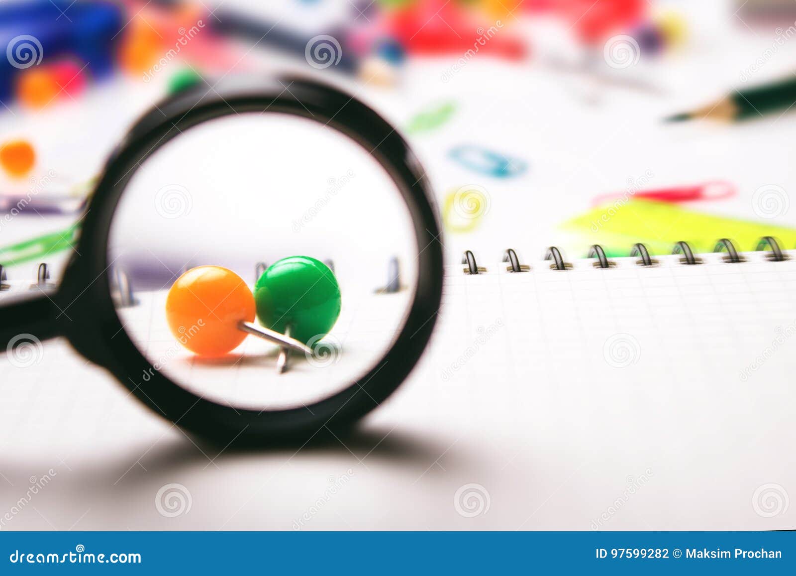 Two Pins in a Magnifying Glass on a Notebook Stock Photo - Image of ...