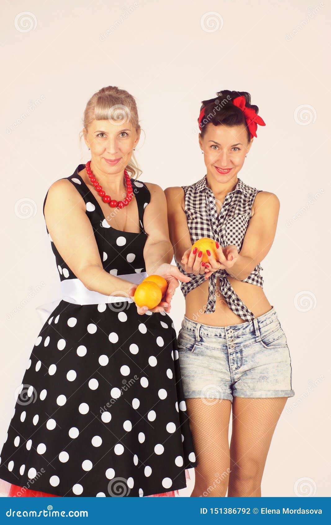 Two Pinup Girlfriends are Holding Oranges in Their Hands, Offering Them ...