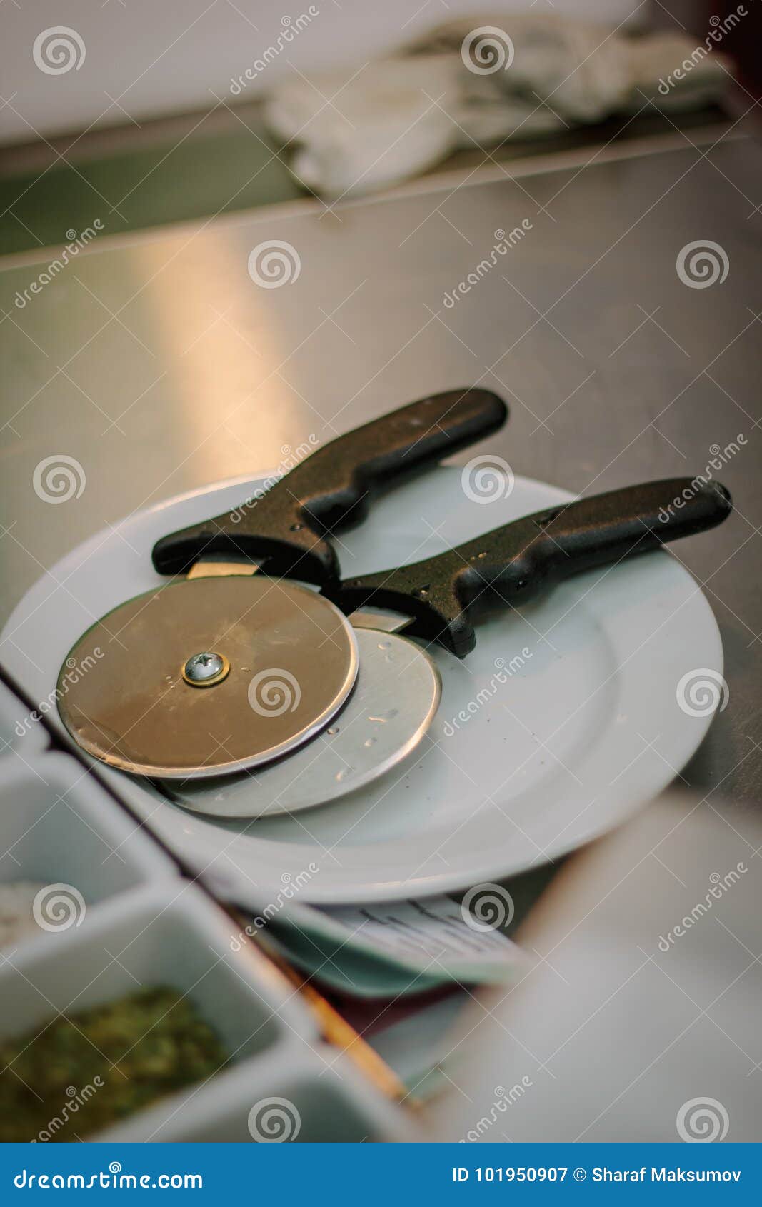 Two Pizza Cutters on White Ceramic Plate. Stock Image - Image of ...