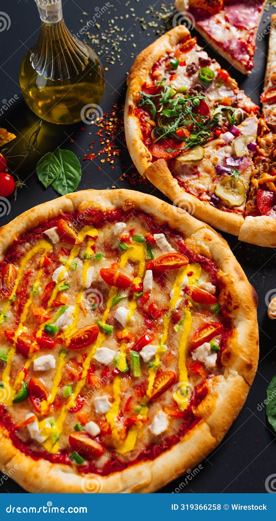 A Couple of Pizzas on Top of a Table Covered in Toppings Stock Photo ...