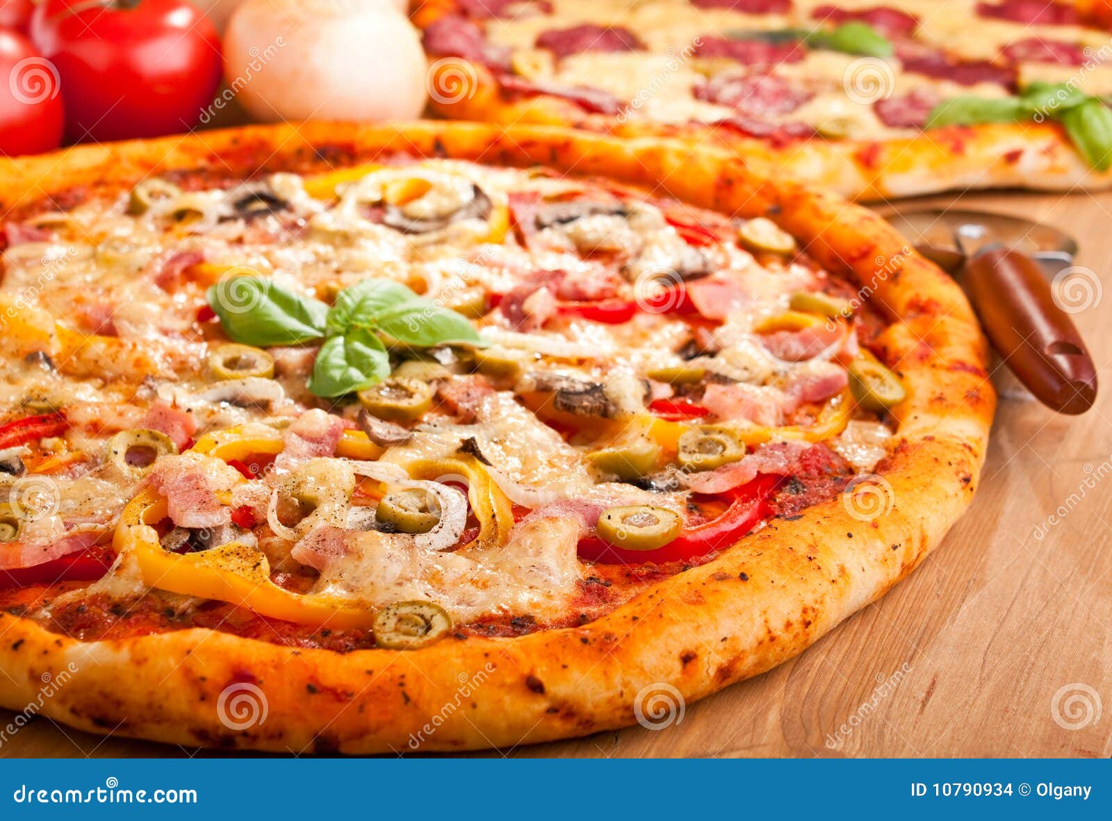 Two pizzas on a table stock photo. Image of onion, leaf - 10790934